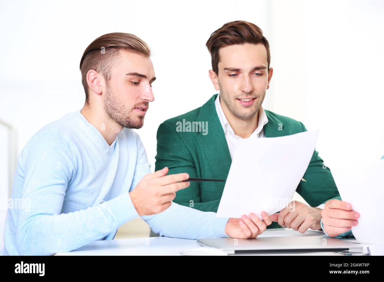 Young business men at the meeting in a conference room Stock Photo - Alamy