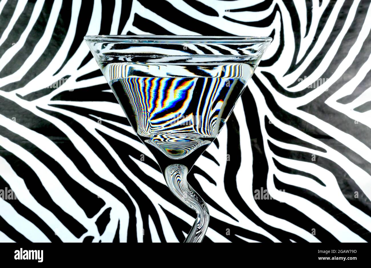 Refraction of light in a glass of water which reverses and distorts the ...