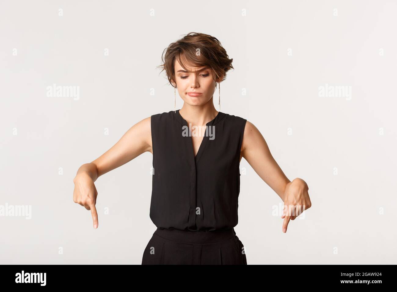 Skeptical and doubtful young caucasian woman smirk hesitant, pointing ...