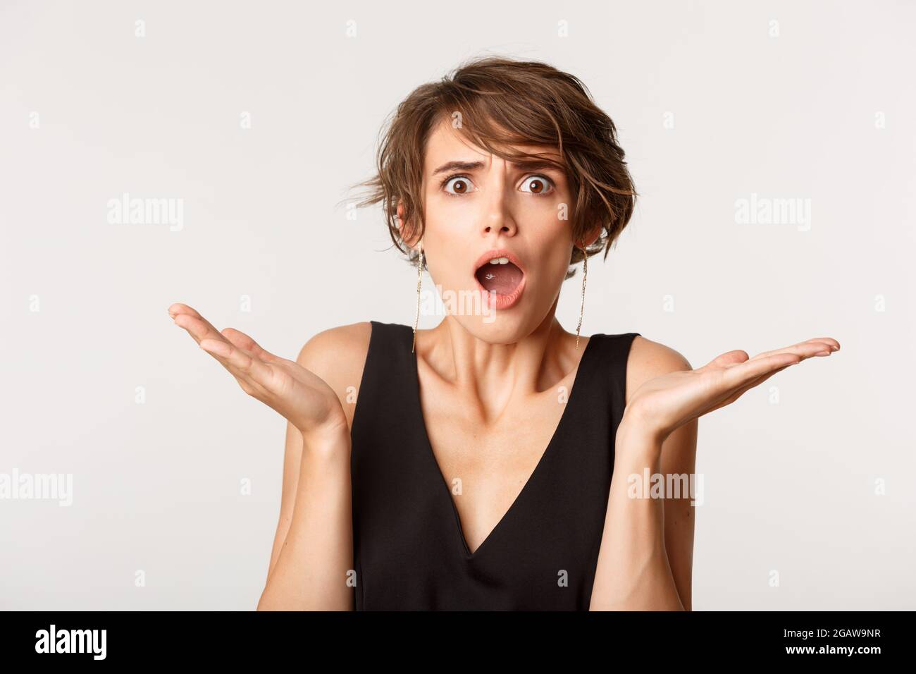 Close-up of shocked upset woman complaining, spread hands sideways and ...