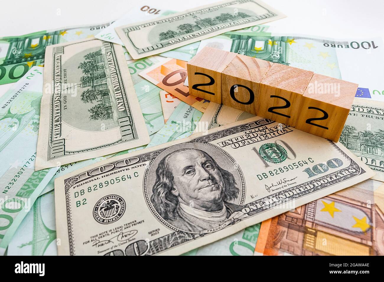 2022 inscription on wooden cubes on the texture of us dollars and euro ...