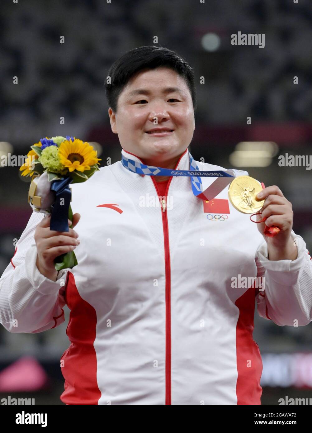 China's Gong Lijiao poses with the gold medal for the women's shot put ...