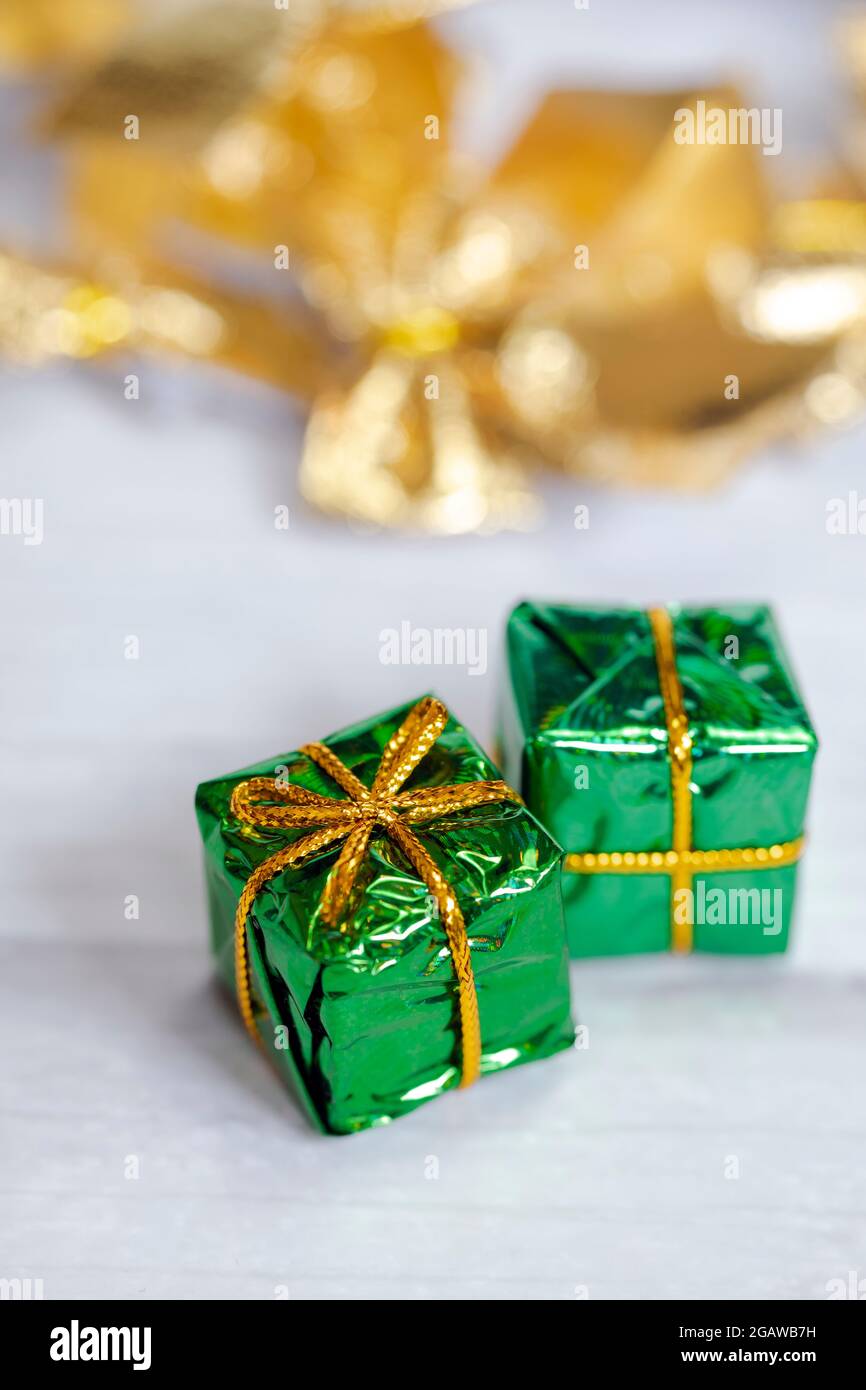 Pile of colored shiny gift boxes with copy space on white wood ...