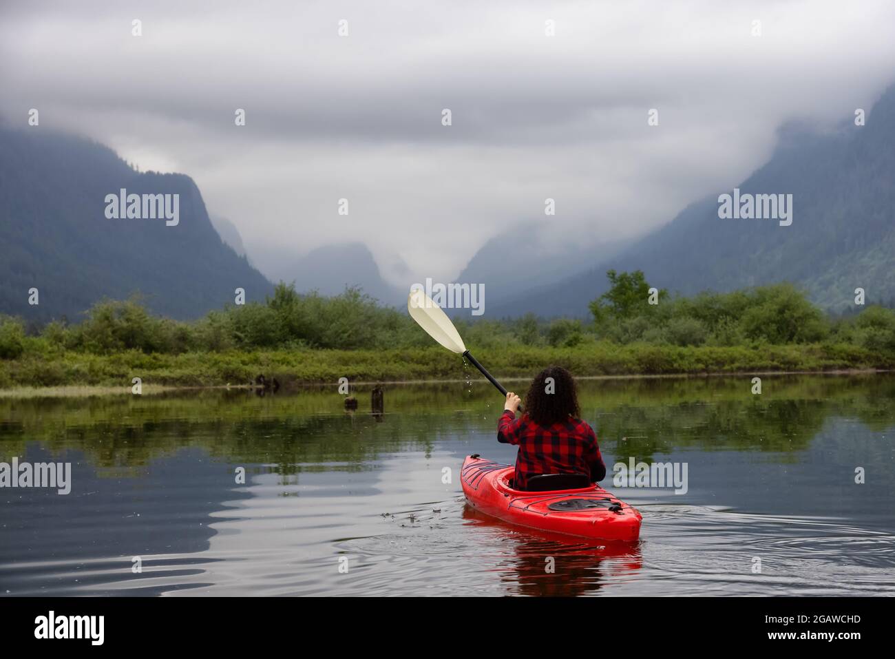 Adventure Caucasian Adult Woman Kayaking in Red Kayak Stock Photo - Alamy
