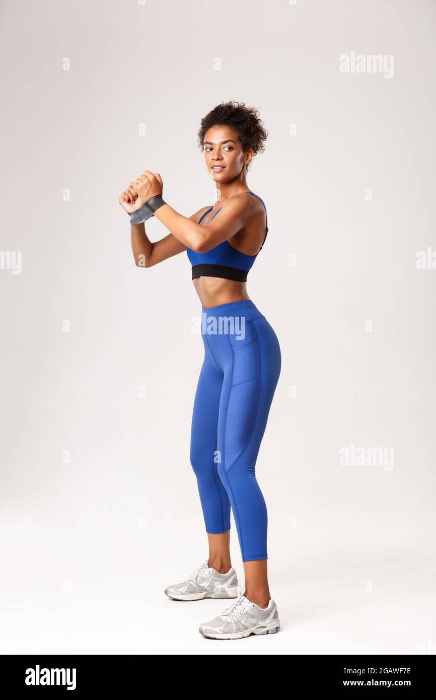 Full length profile shot of attractive african-american fitness girl in ...