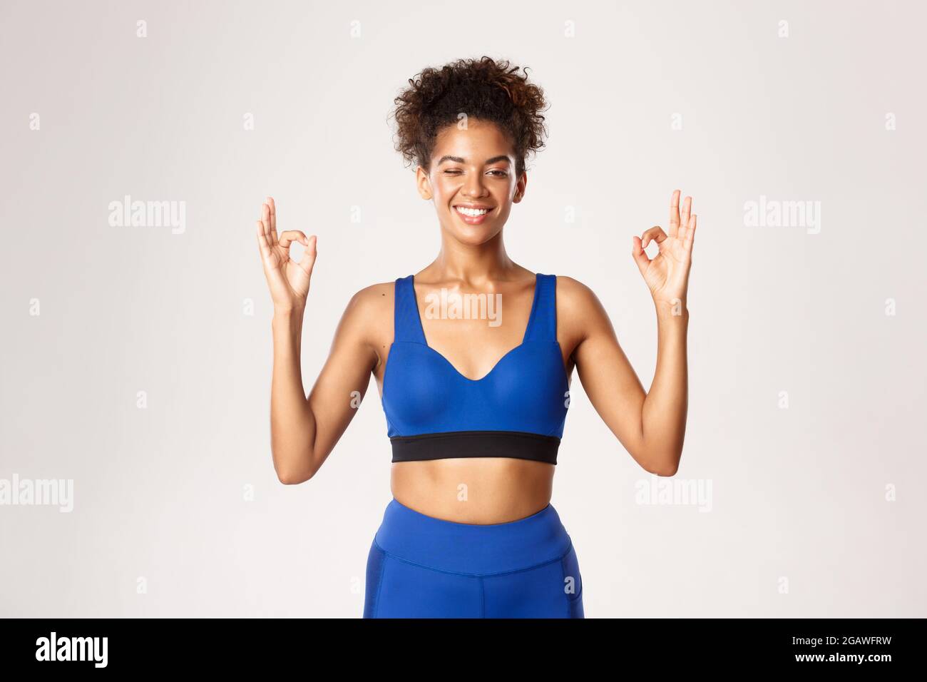 Waist-up of healthy and strong african-american female athelte, winking ...