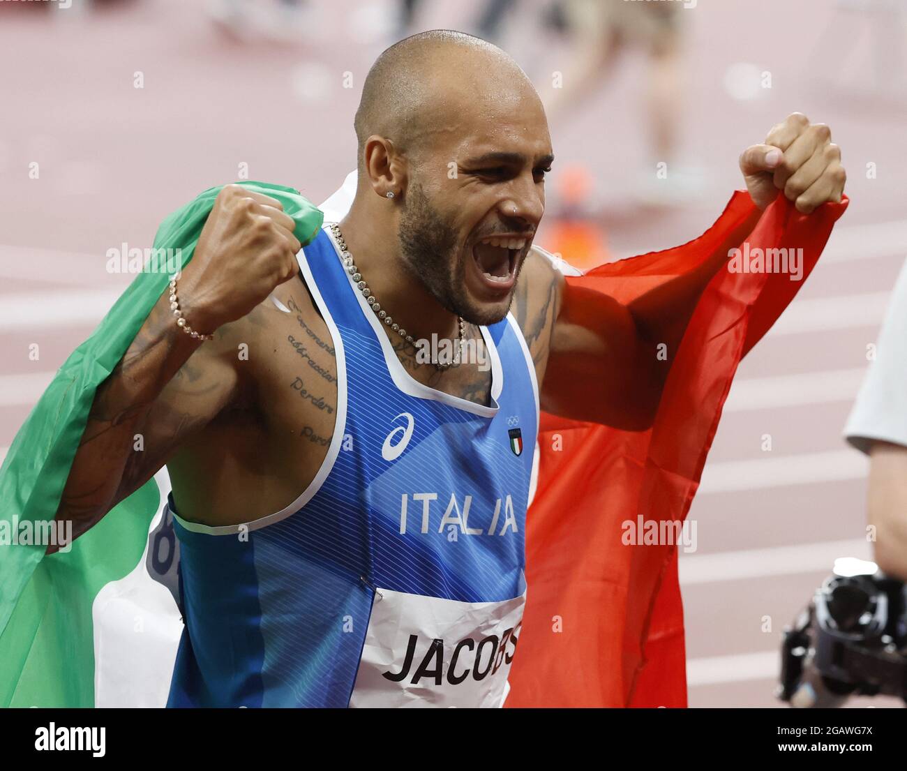 Tokyo, Japan. 01st Aug, 2021. Italy's Lamont Marcell Jacobs celebrates ...