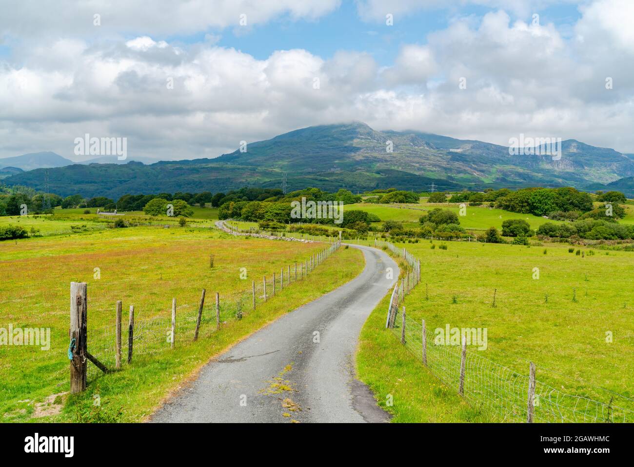 A country road and view of rural Welsh landscape in Snowdonia region in ...