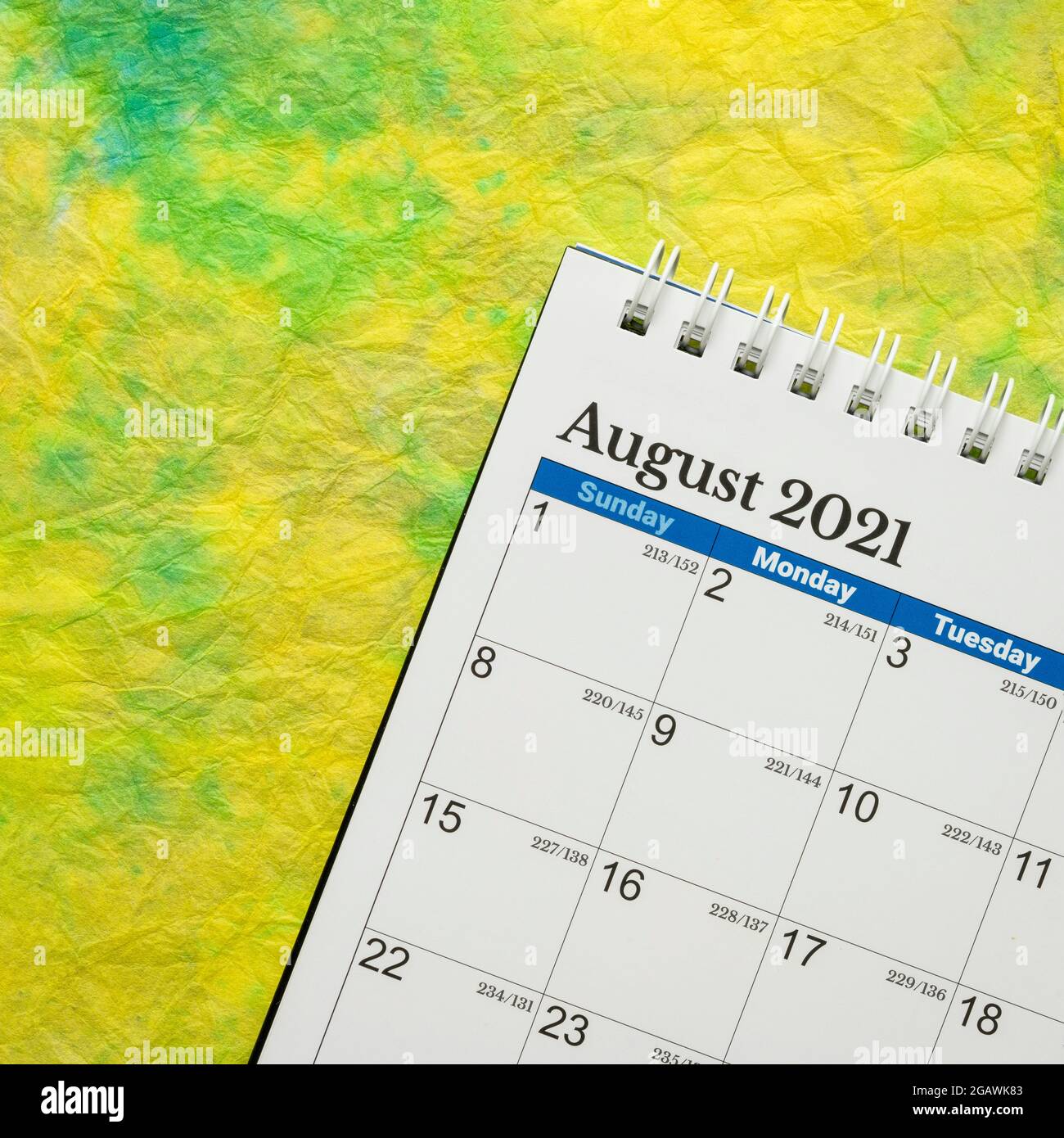 August 2021 - spiral desktop calendar against colorful marbled paper ...