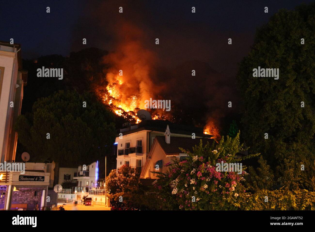 Smoke and flames rise from a forest fire in Marmaris district in Mugla ...