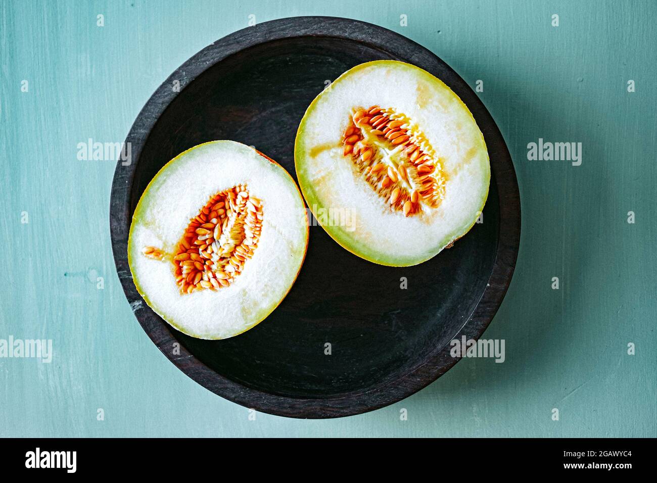 Ogen Melon, Halved on Plain Background with Copyspace, Room for Text ...