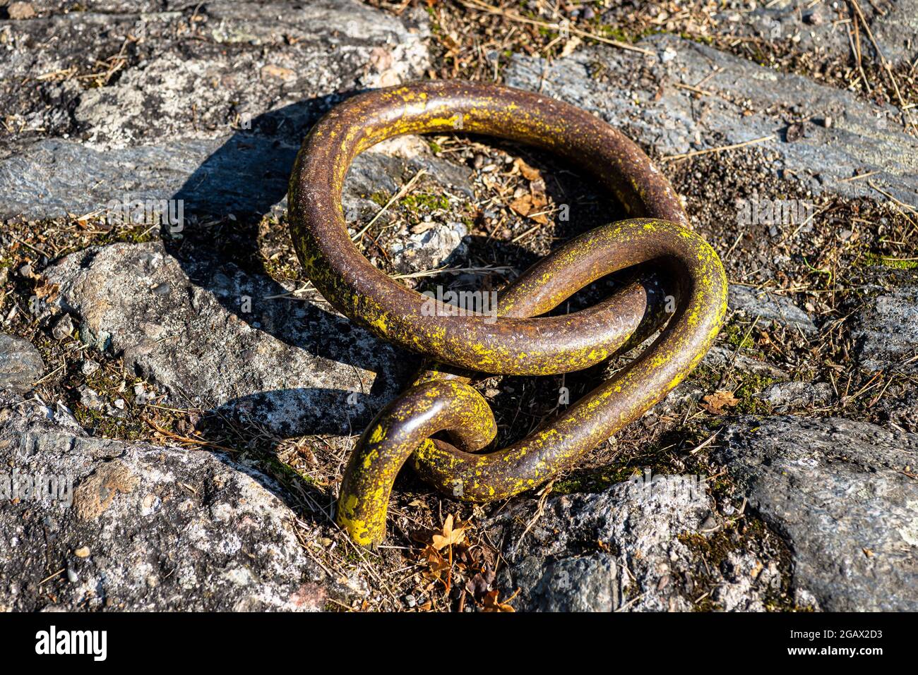 A steel hawser in the shape of a chain eyelet driven into the ground at ...
