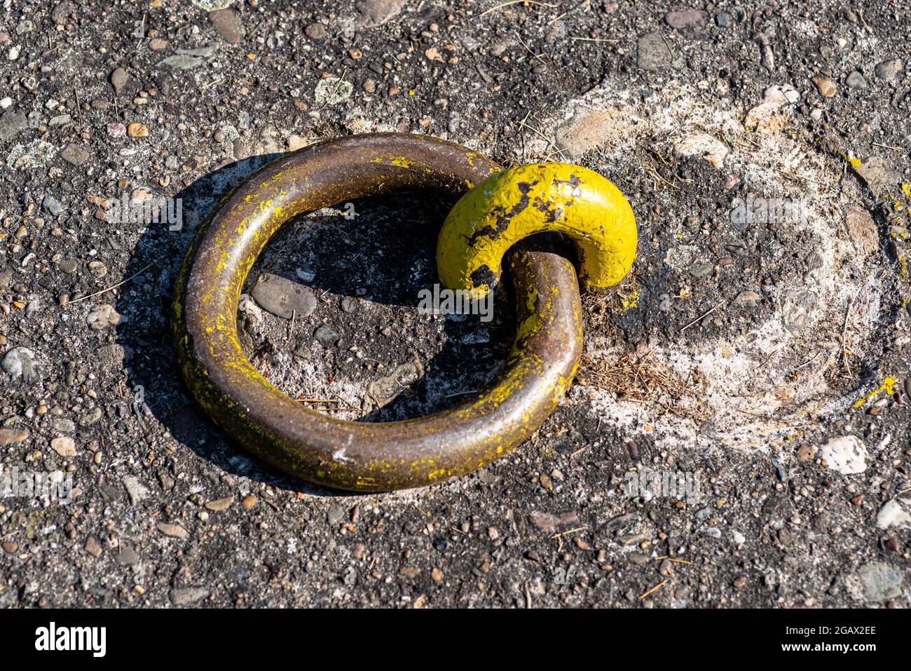 A steel hawser in the shape of a chain eyelet driven into the ground at ...