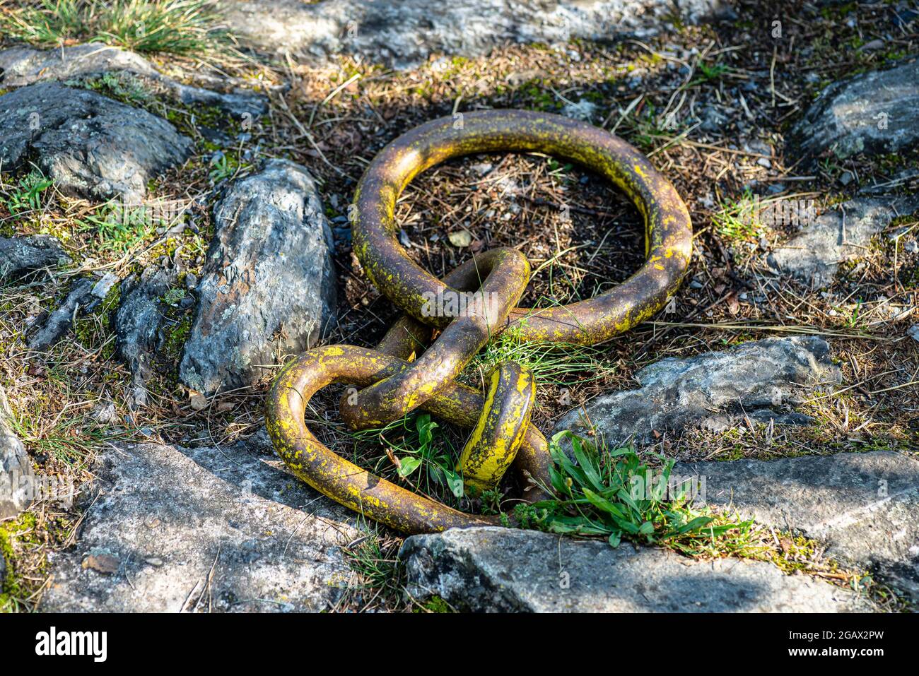 A steel hawser in the shape of a chain eyelet driven into the ground at ...