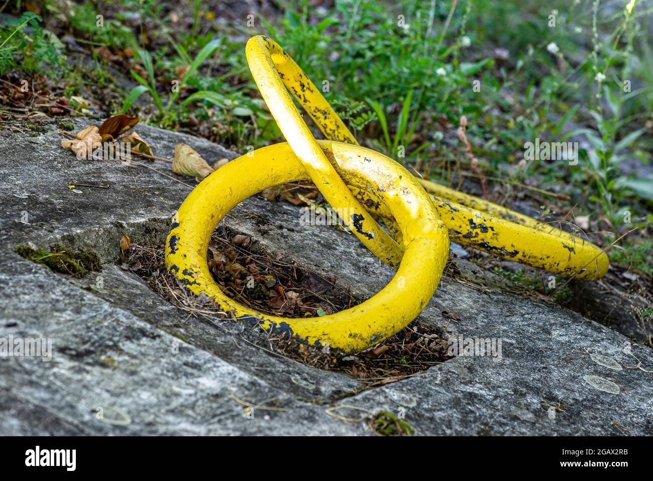 A steel hawser in the shape of a chain eyelet driven into the ground at ...