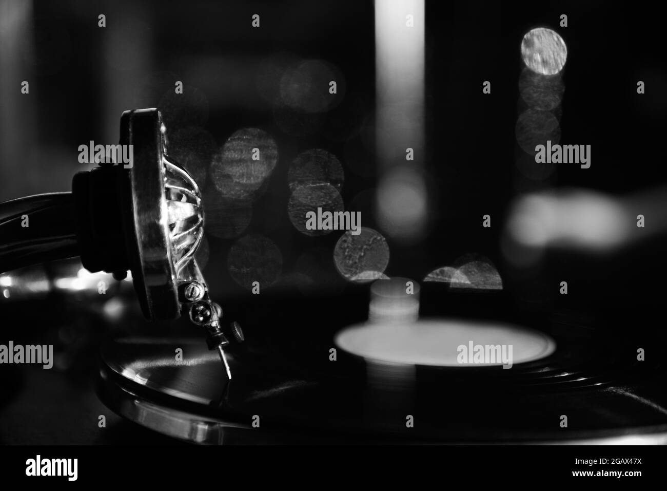 Turntable with vinyl record on dark blurred background Stock Photo - Alamy