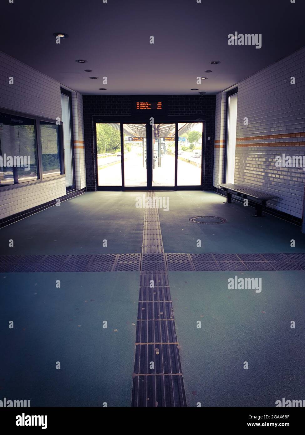 Long hall with exit at the end Stock Photo - Alamy