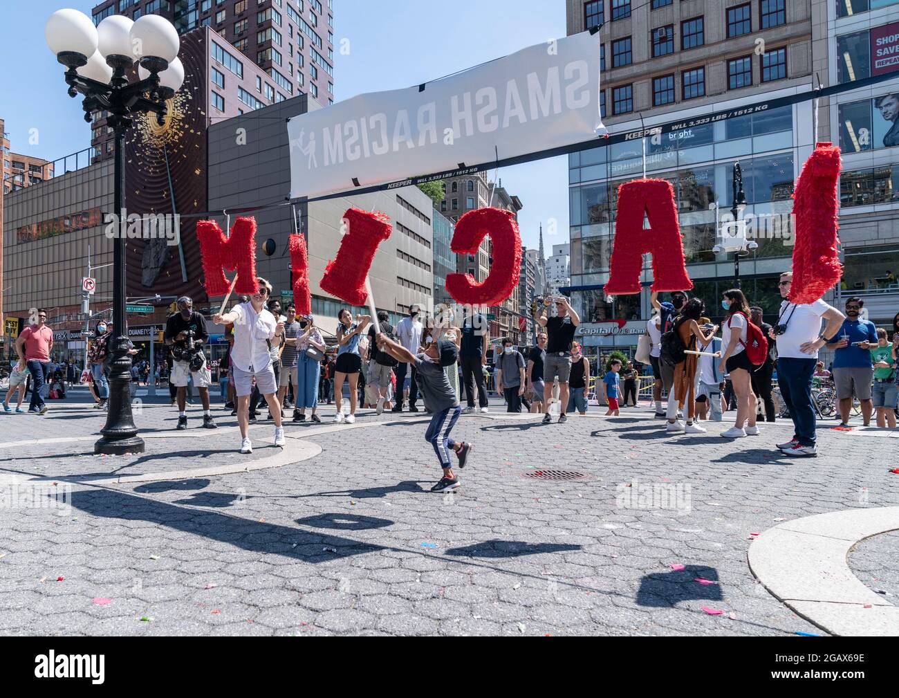 New York, NY - July 31, 2021: People smash word Racism as part of art ...