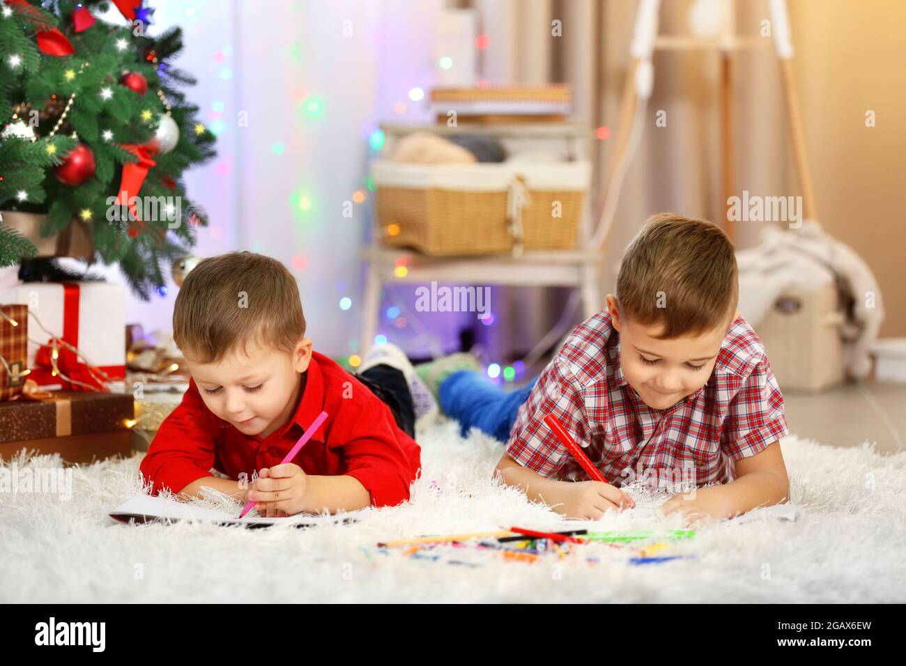 Two cute small brothers drawing on Christmas tree background Stock ...