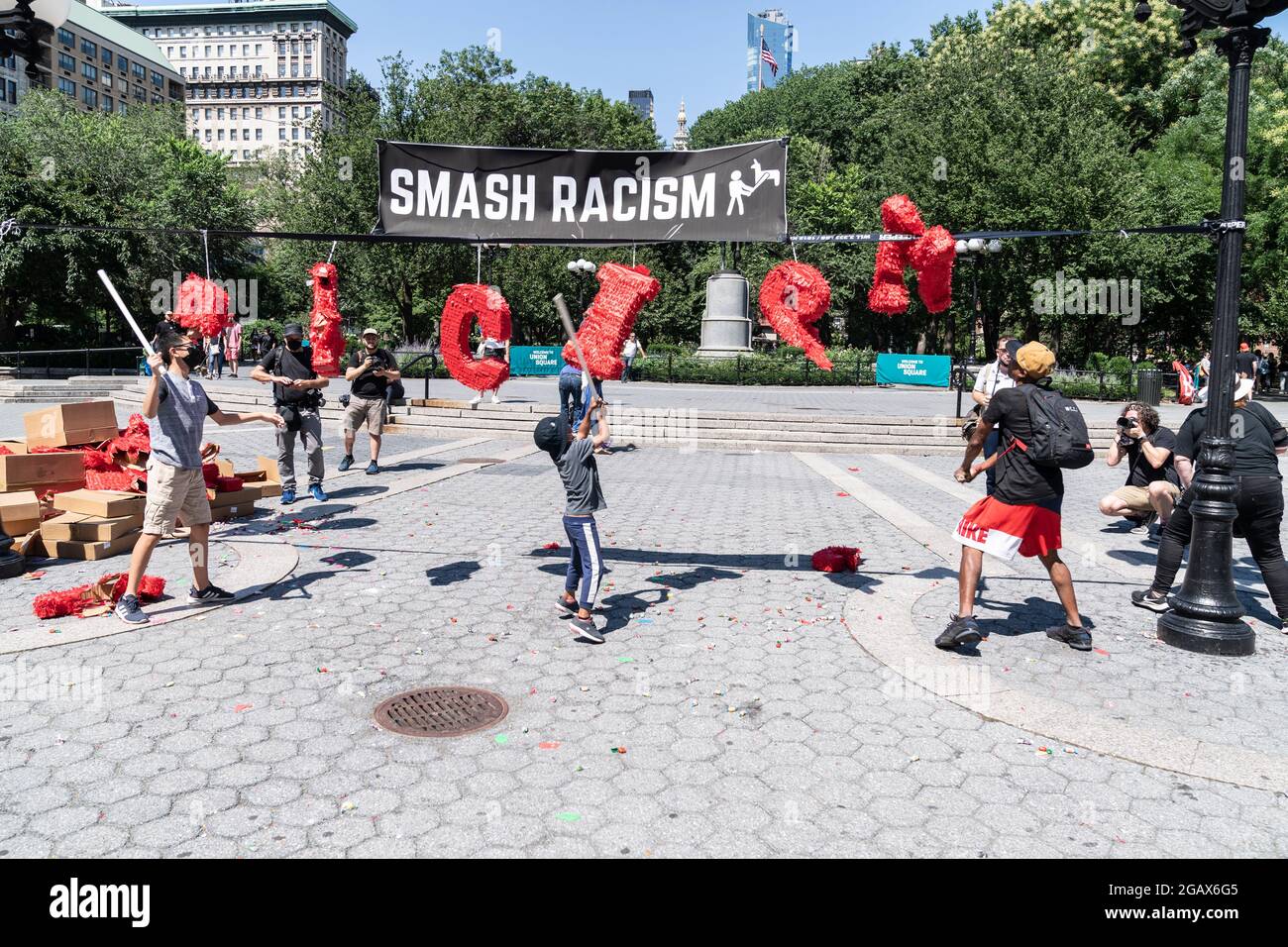 New York, NY - July 31, 2021: People smash word Racism as part of art ...