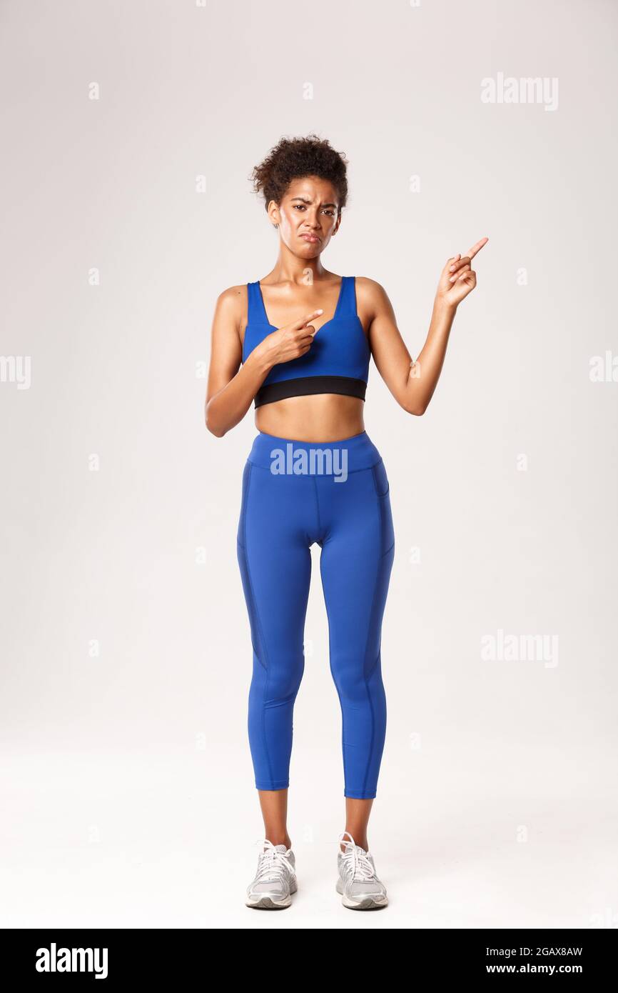 Full length of skeptical and disappointed african-american sportswoman ...