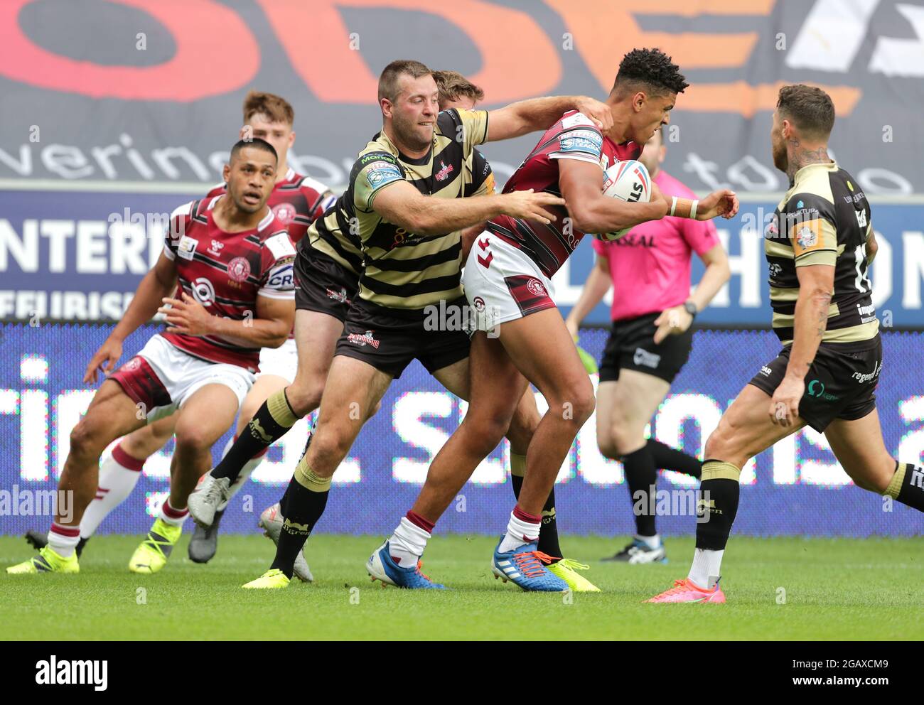 Wigan Warriors' Kai Pearce-Paul is tackled by Leigh Centurions players ...