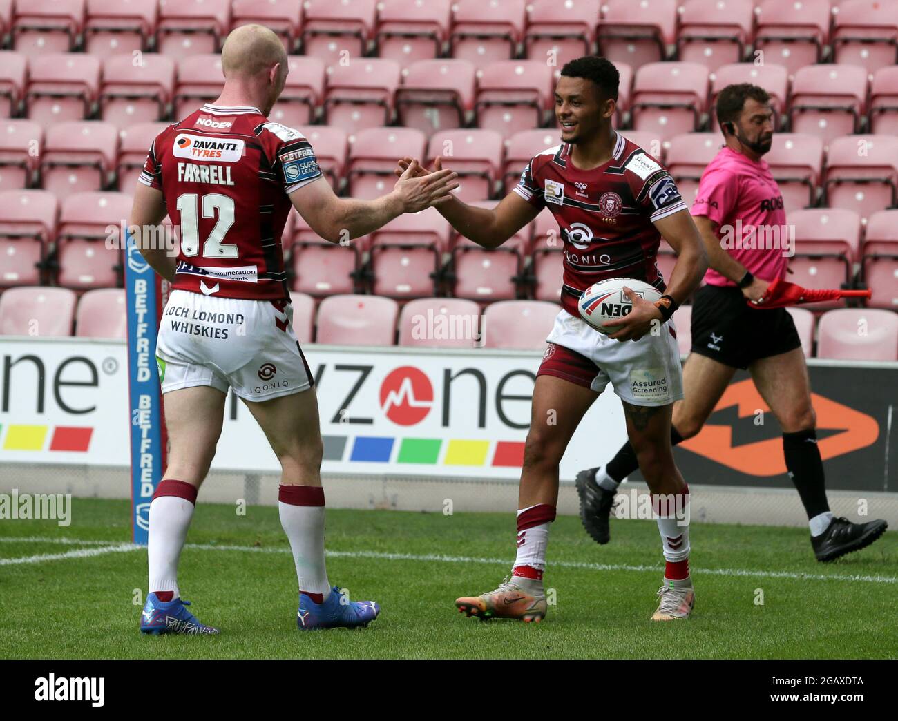Wigan Warriors' Umyla Hanley (right) celebrates scoring his side's ...