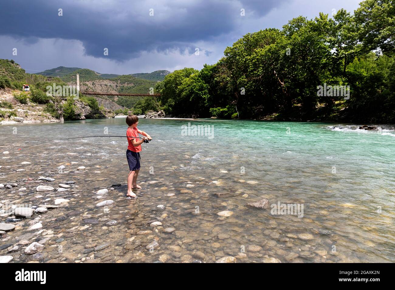 Boy fishing on a beautiful vjosa river in albania Stock Photo - Alamy
