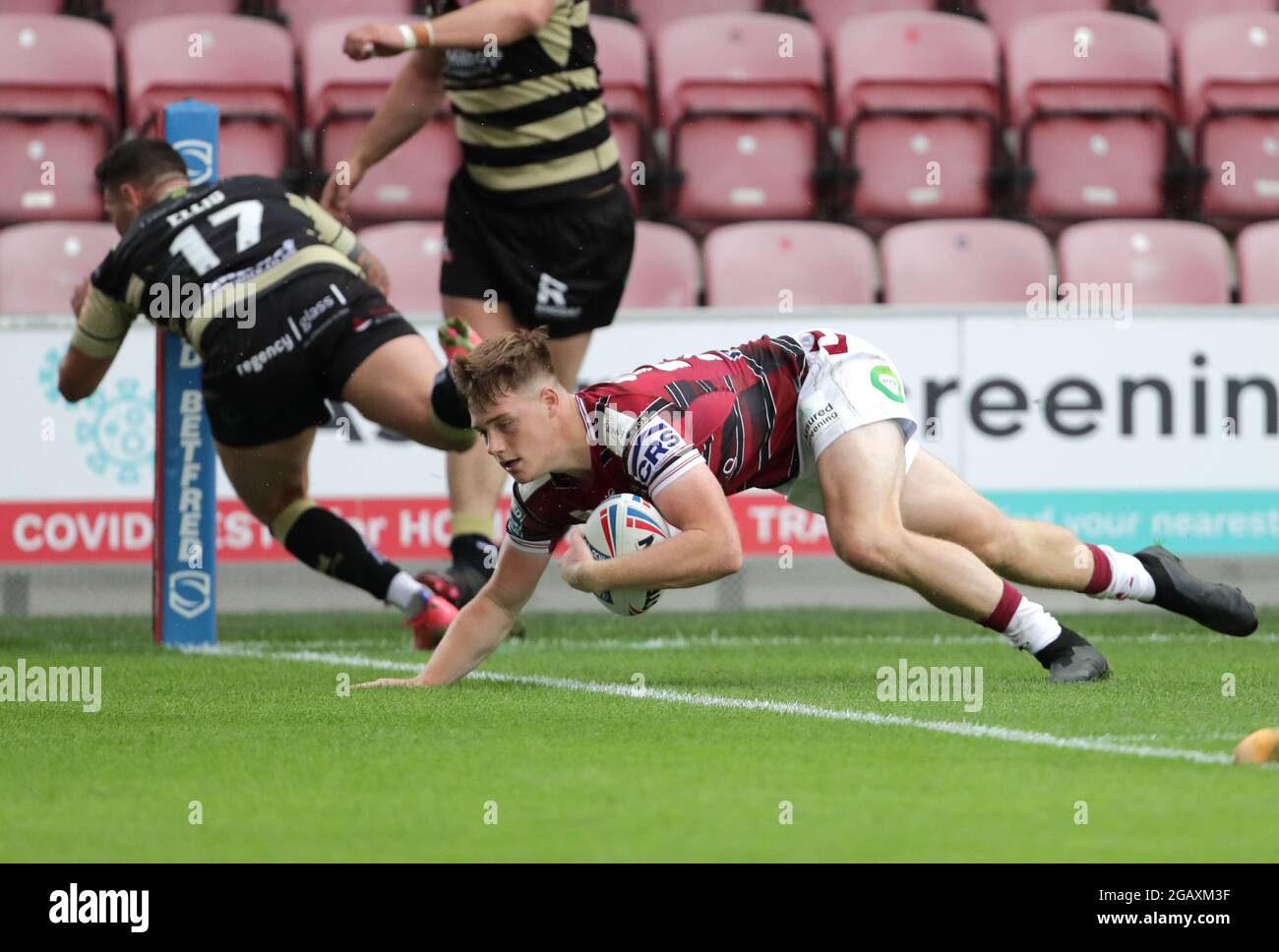 Wigan Warriors' Sam Halsall scores of his side's sixth try of the game ...