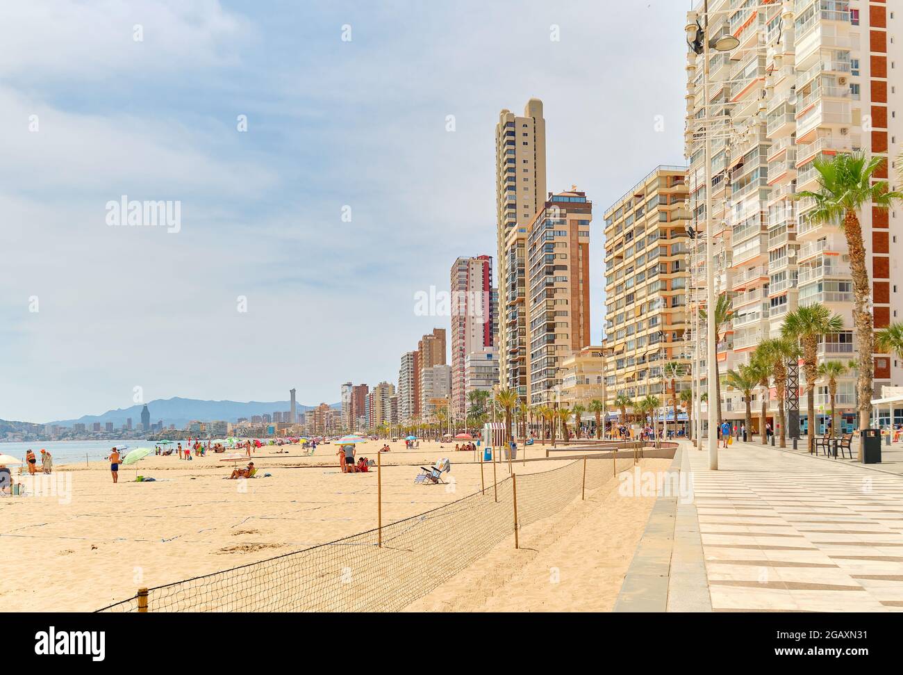 Beach of Benidorm at sunny summer day, city skyline background. Modern ...