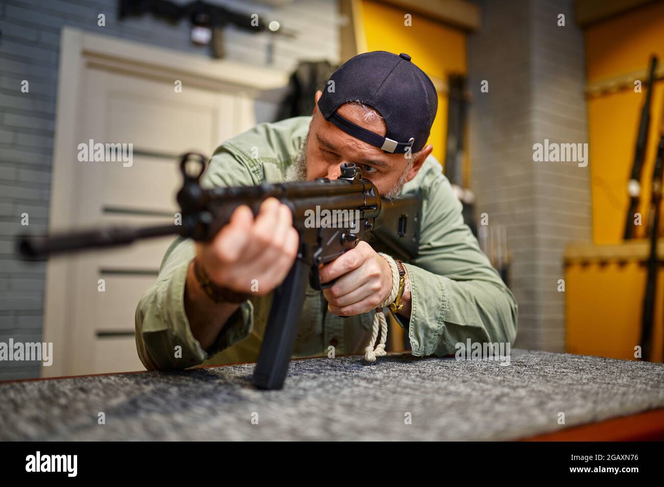 Bearded man checks the rifle scope in gun store Stock Photo - Alamy