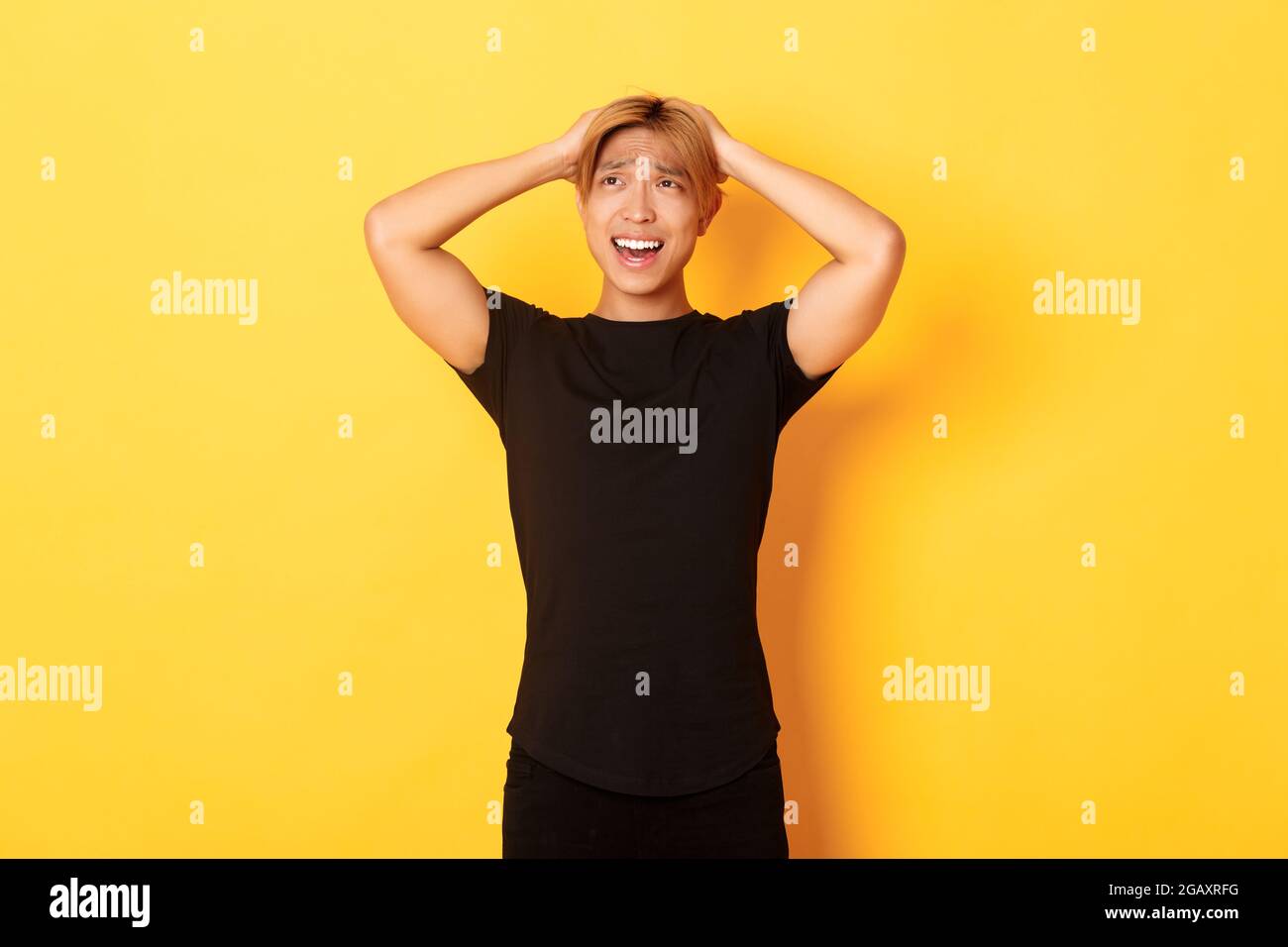 Portrait of young asian guy panicking, looking anxious and upset ...