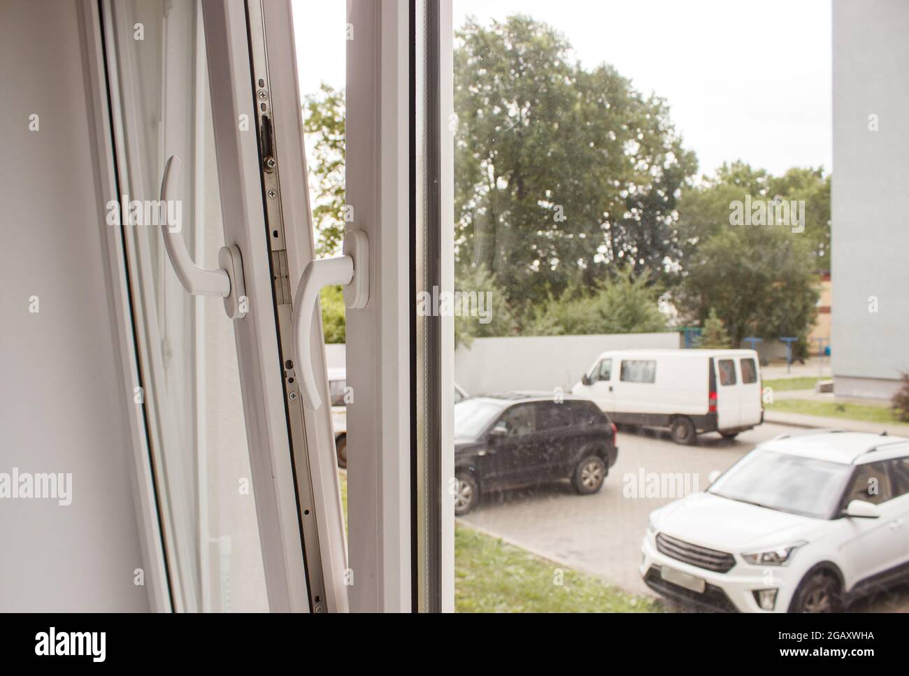 handles of opened white plastic window indoor closeup Stock Photo - Alamy