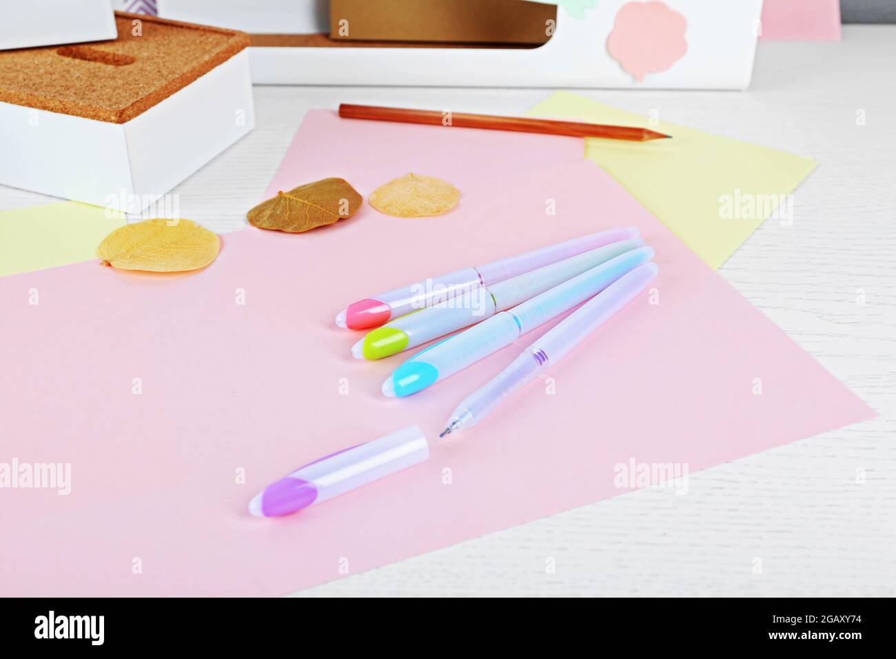 Set of coloured pens on a paper over white background Stock Photo - Alamy