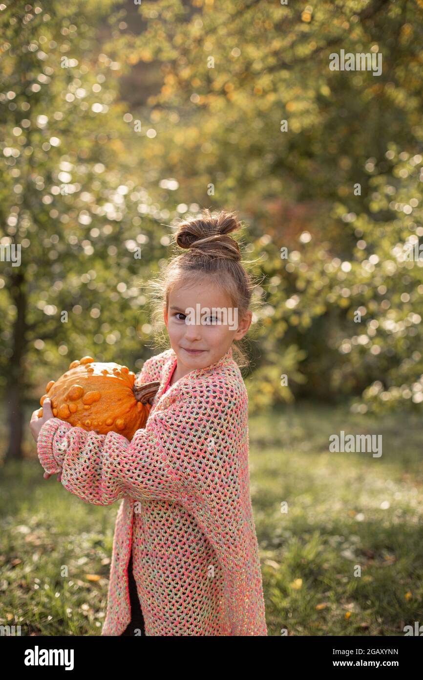 Deformed ugly orange pumpkin in a child hands Stock Photo - Alamy