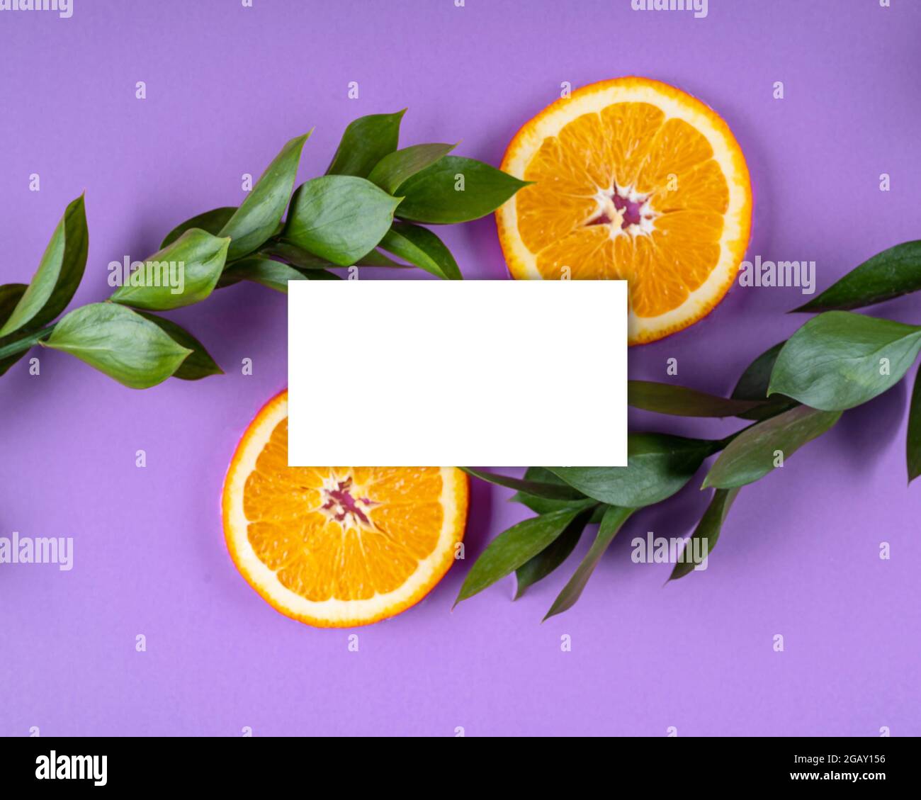 White paper card note bright flower leaf and orange fruit composition ...