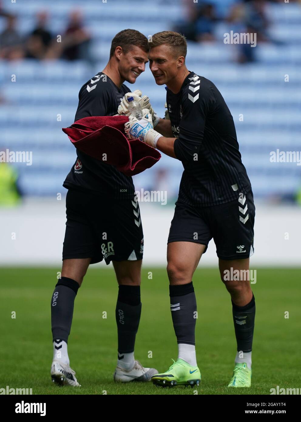 Coventry City goalkeepers Ben Wilson (left) and Simon Moore switch ...