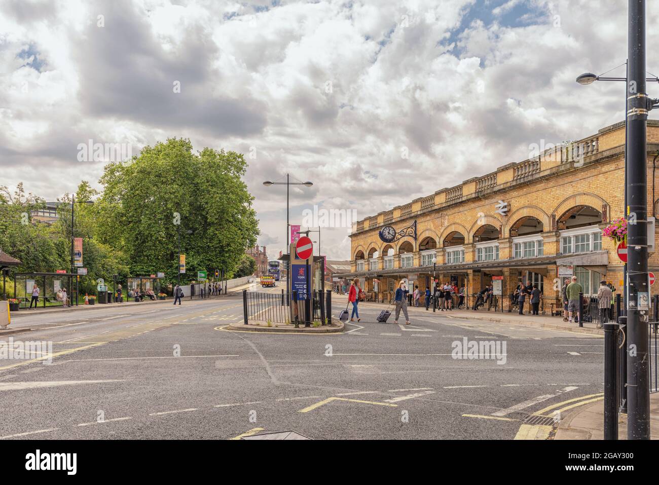 The external view of a railway station. A brick building stands on one ...