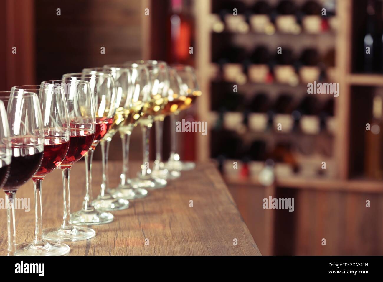 Many glasses of different wine in a row on bar counter Stock Photo - Alamy