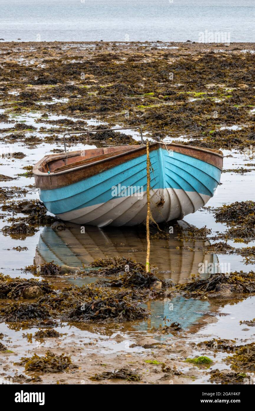 small blue painted rowing boat on the beach at st helens duver ...