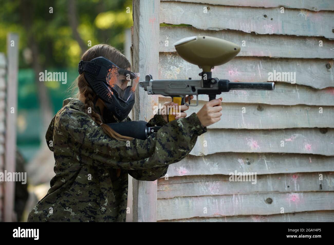 Paintball warrior shoots with gun from the shelter Stock Photo - Alamy