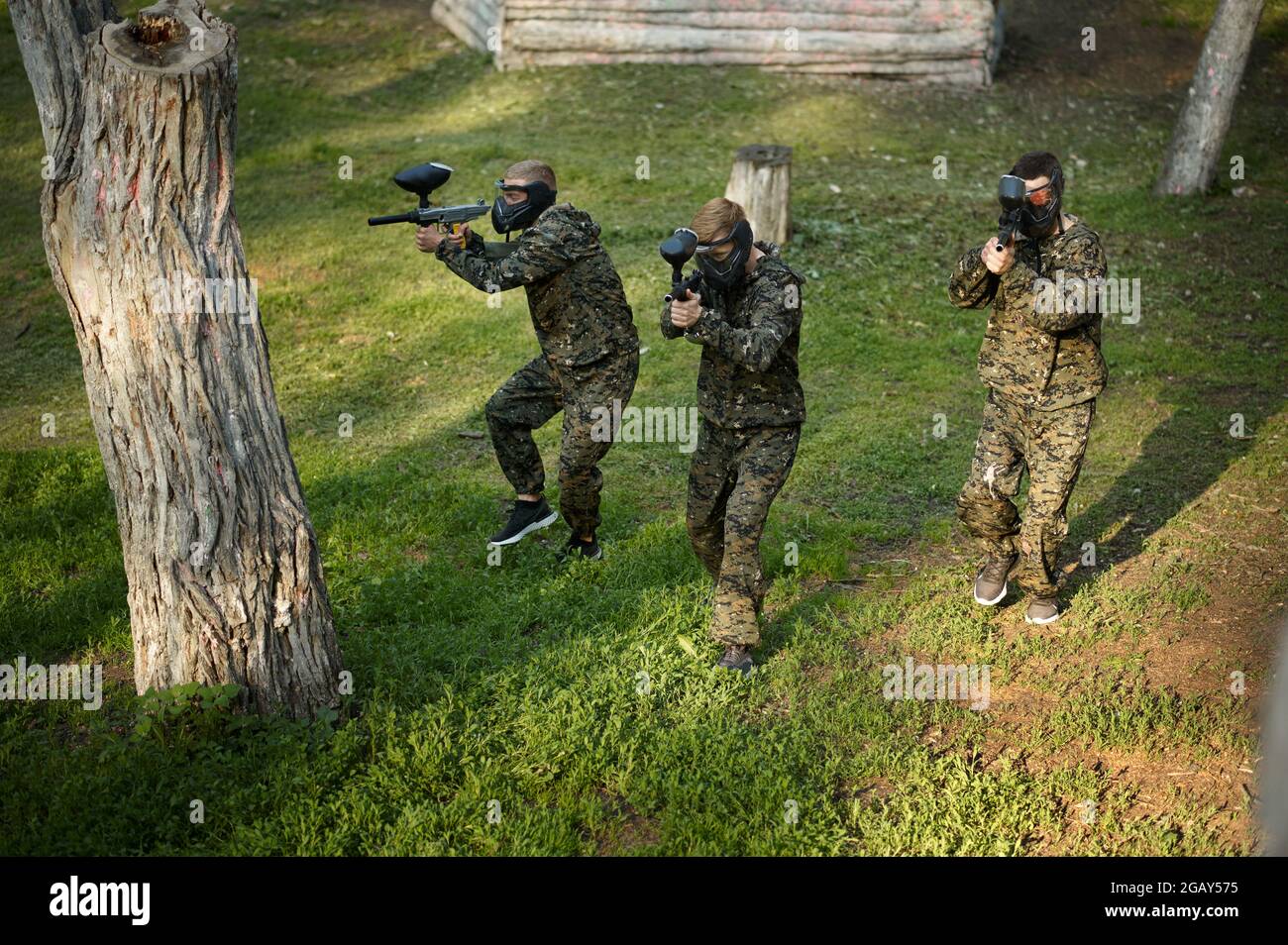 Team in uniform playing paintball in the forest Stock Photo - Alamy