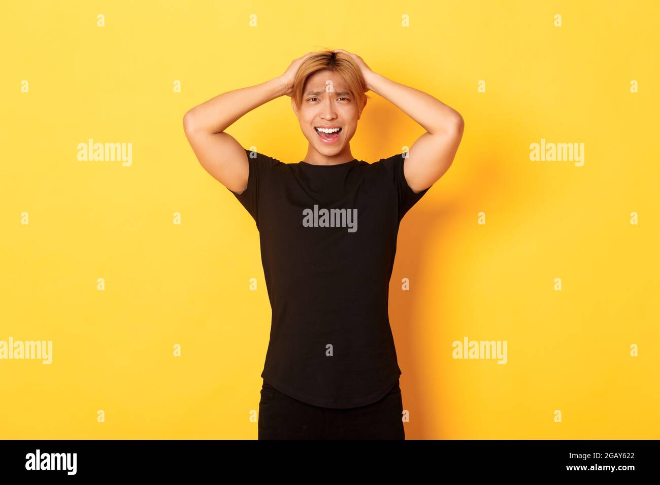 Portrait of young asian guy panicking, looking anxious and upset ...