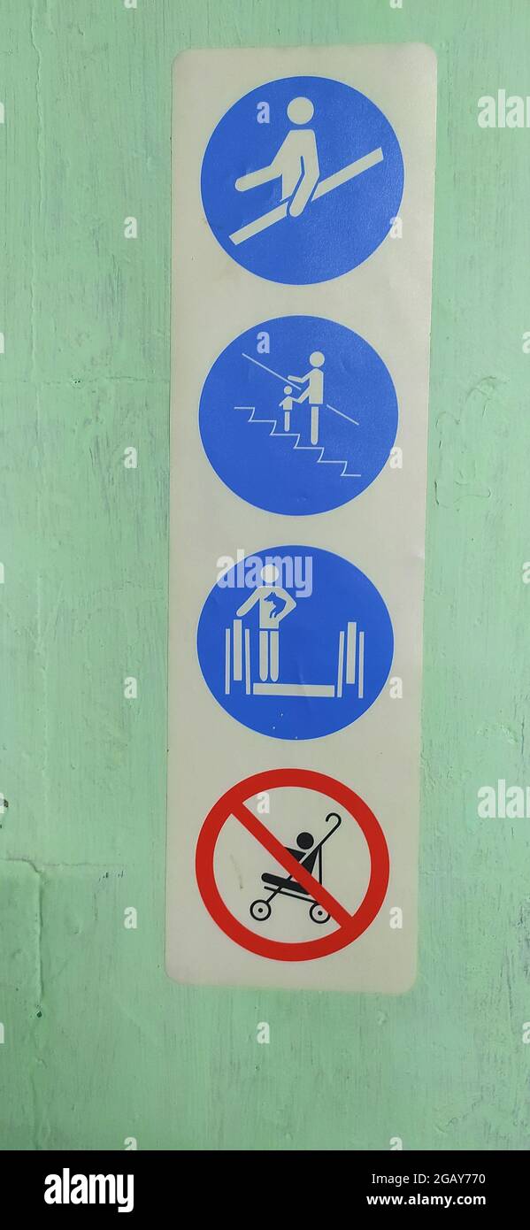 Signs on an escalator, warning signs, the escalator at the Building ...