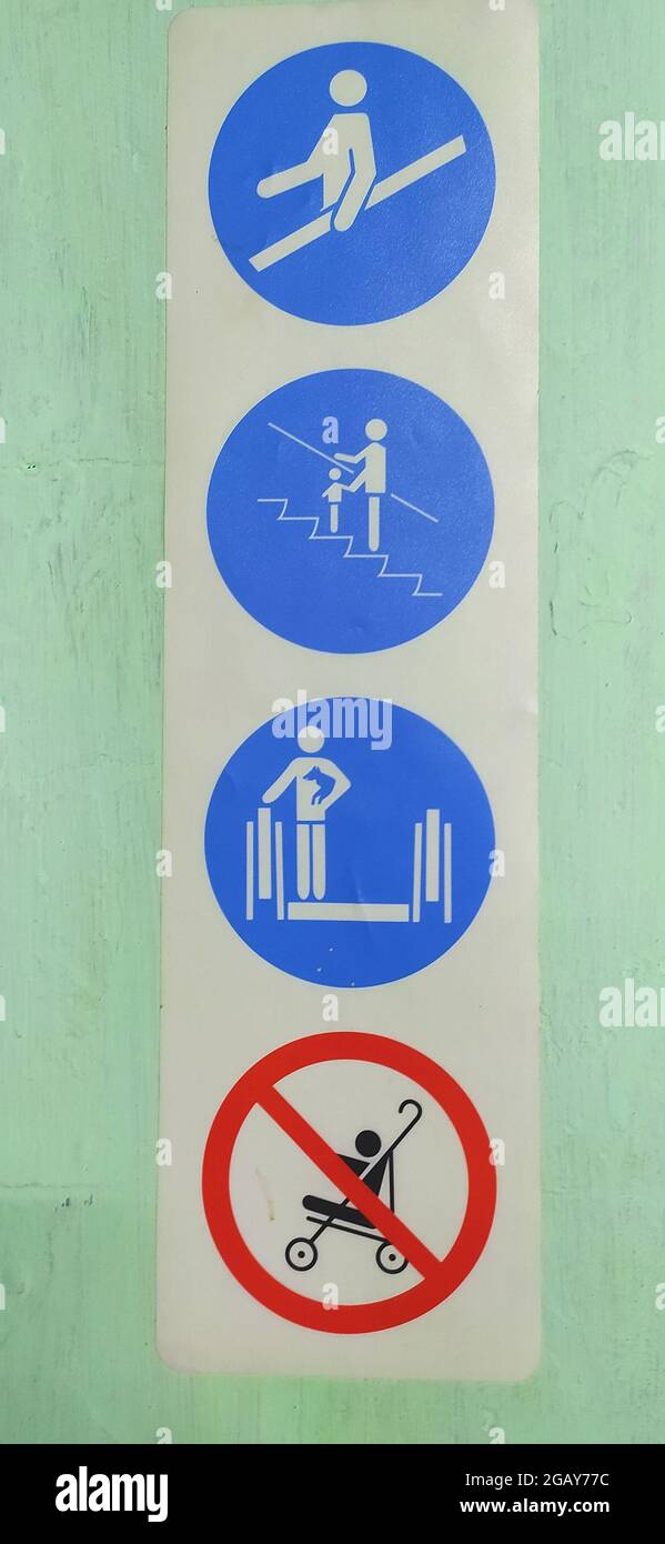 Signs on an escalator, warning signs, the escalator at the Building ...