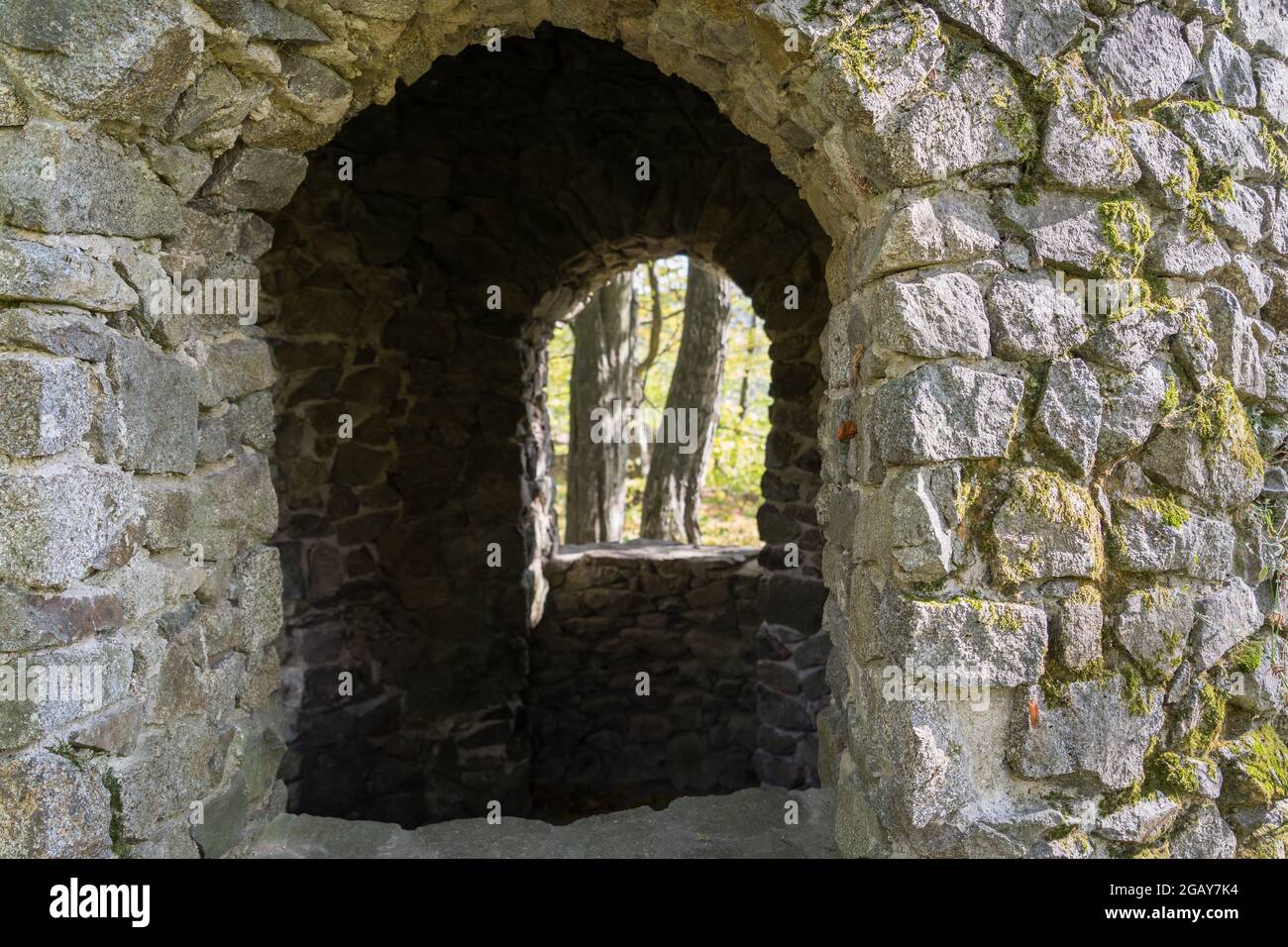 view through historical arch windows of a romantic medieval stone ruin ...