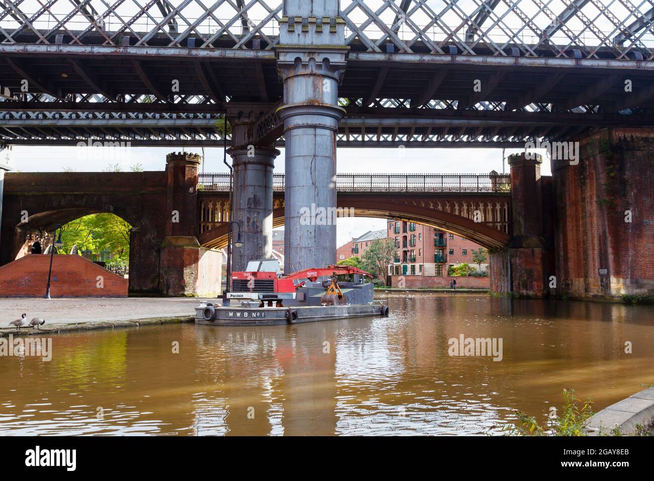 Black floating barge with a Poclain TP 45 crane moored by the ...