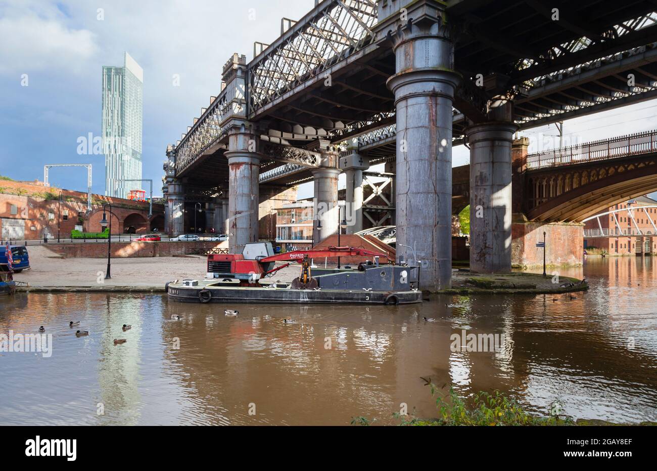Black floating barge with a Poclain TP 45 crane moored by the ...