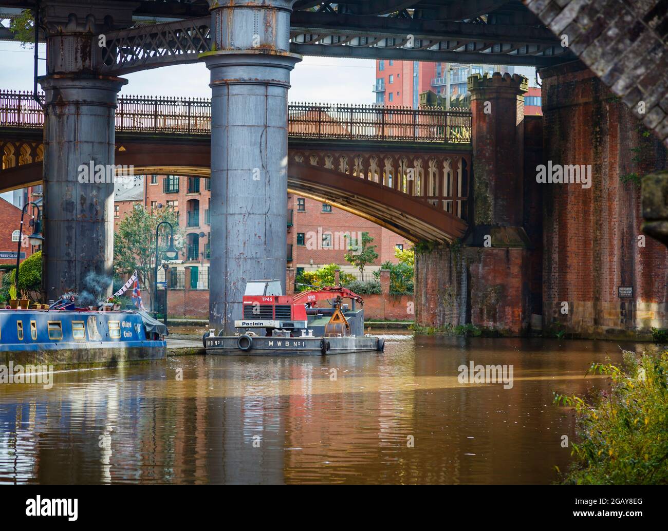 Black floating barge with a Poclain TP 45 crane moored by the ...