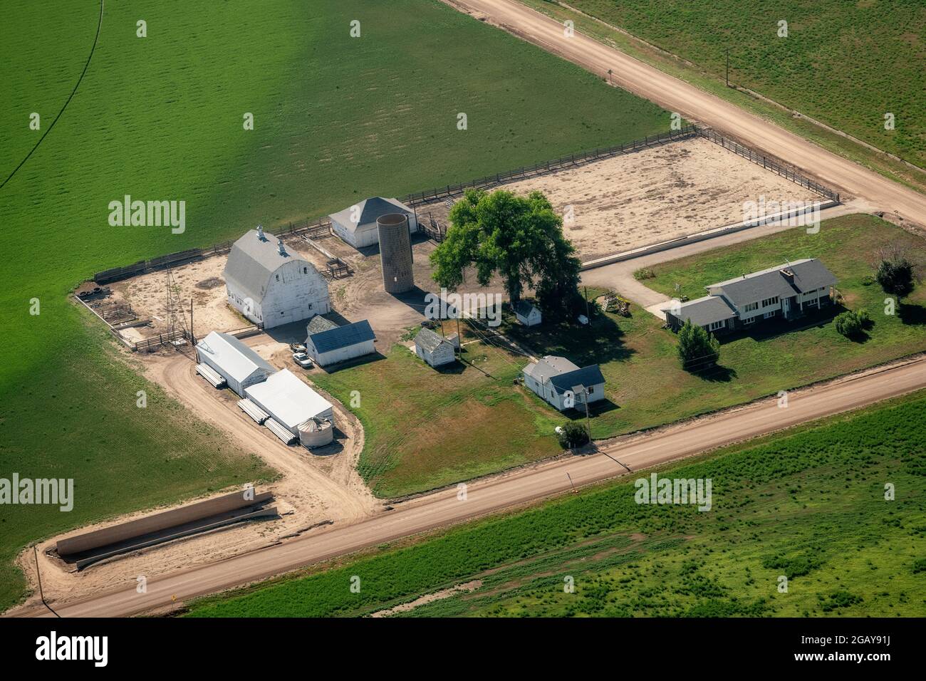 Aerial view of a farm with a barn and crops in the field Stock Photo ...